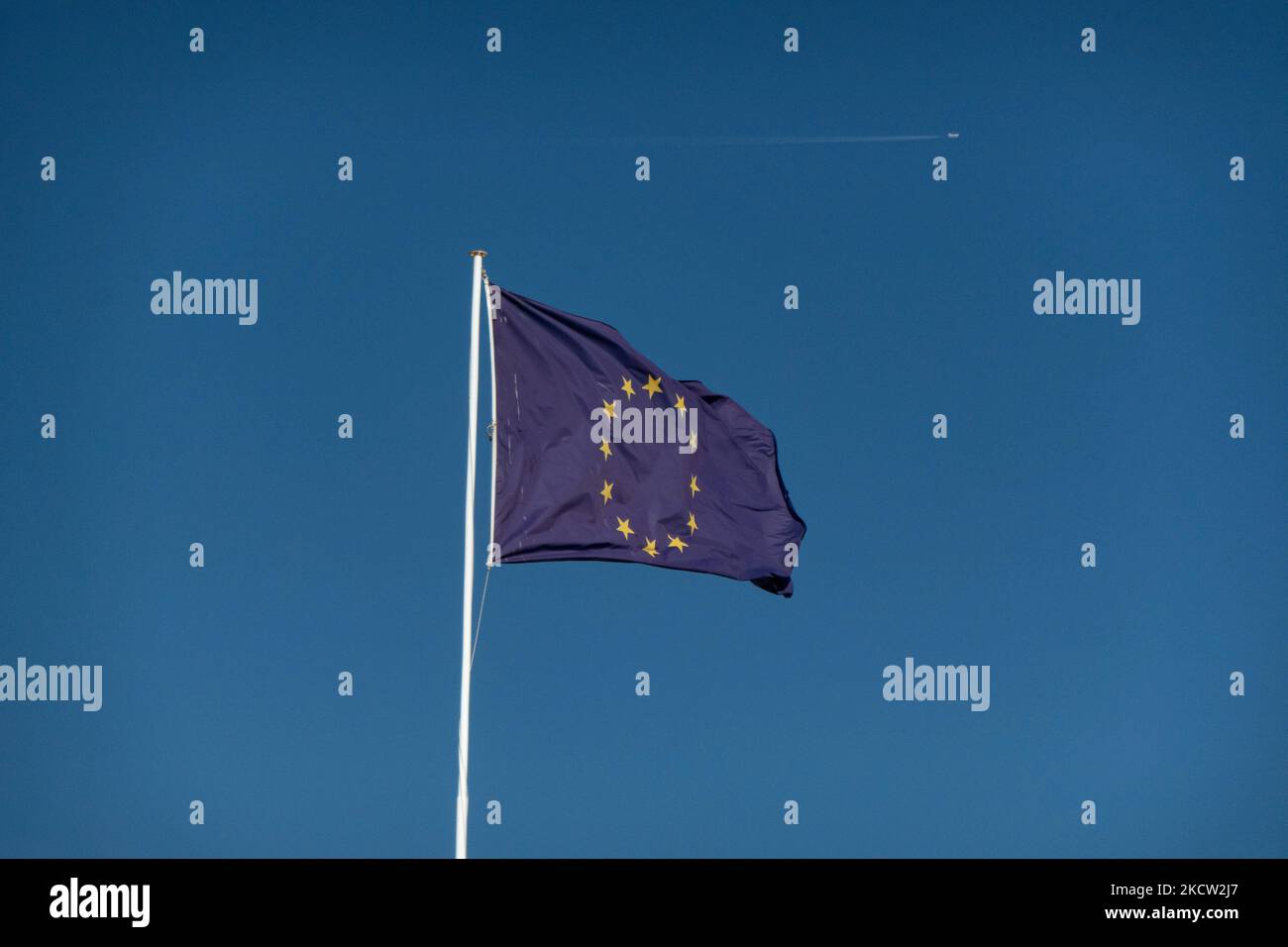 Flag of Europe waving in the blue sky during a sunny day in the Greek ...