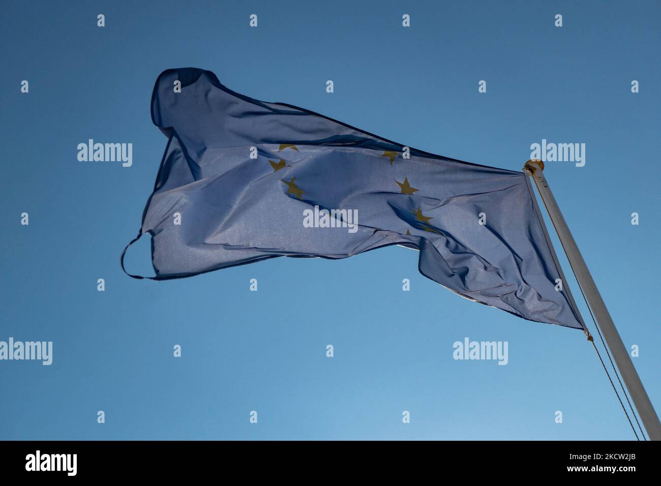 Flag of Europe waving in the blue sky during a sunny day in the Greek ...