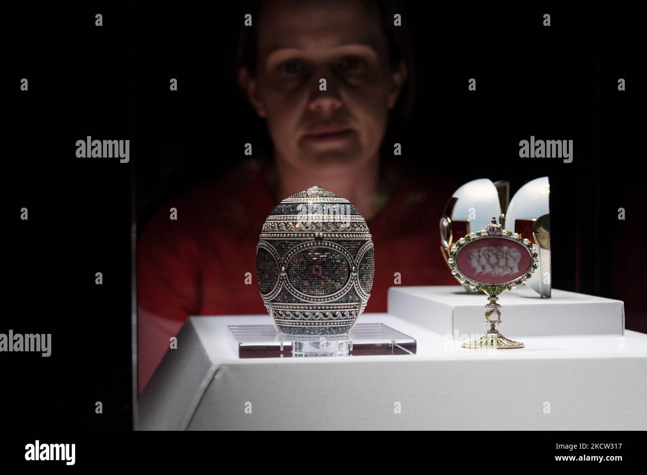 LONDON, UNITED KINGDOM - NOVEMBER 17, 2021: A staff member looks at the Red Cross with Triptych ...