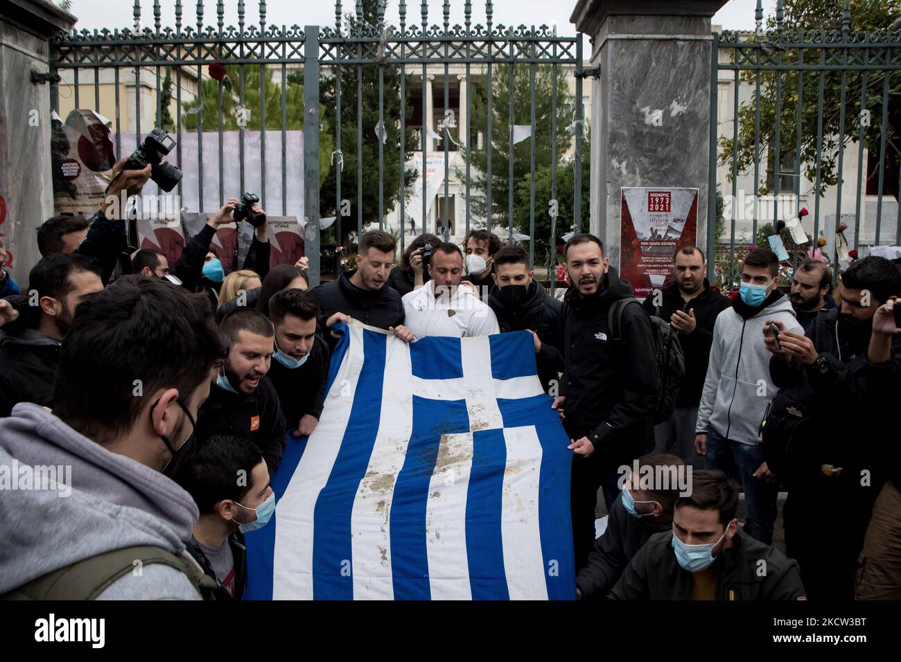 Athens' Polytechnic school students carry a blood-stained Greek flag ...
