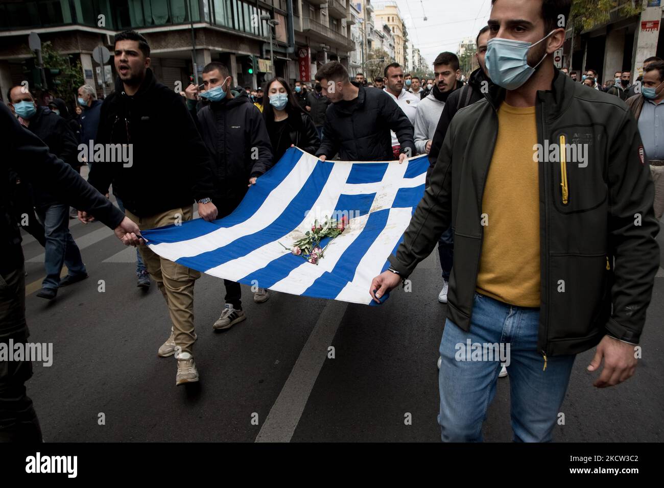Athens' Polytechnic school students carry a blood-stained Greek flag ...