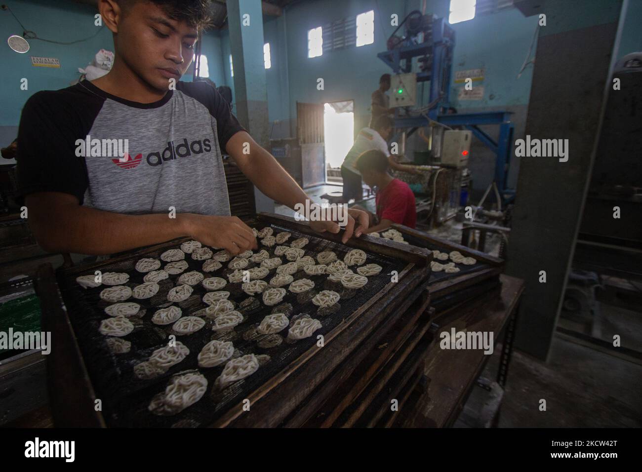 Workers make crackers or locally known as Kerupuk at Yogi Kerupuk a ...