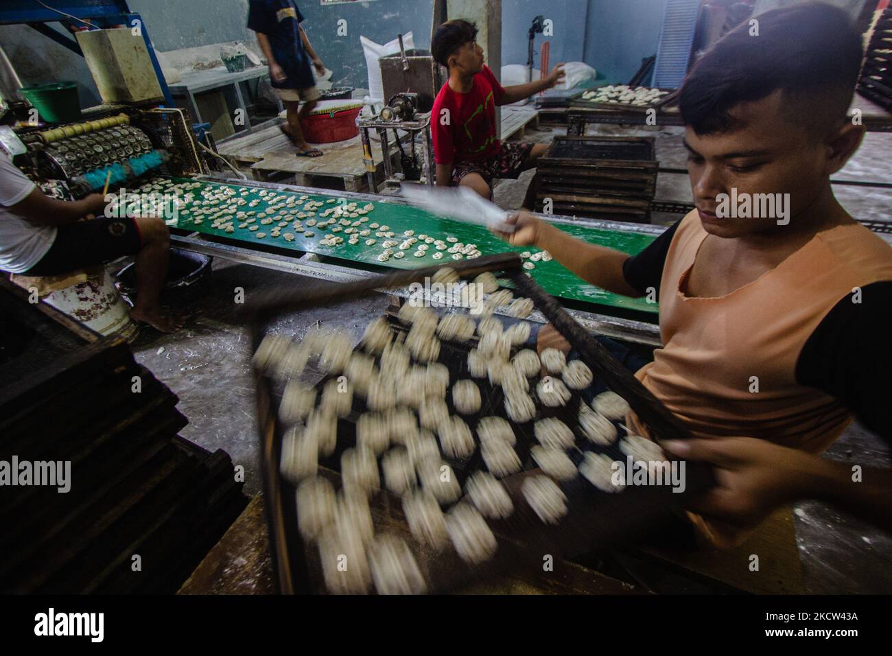 Workers make crackers or locally known as Kerupuk at Yogi Kerupuk a ...