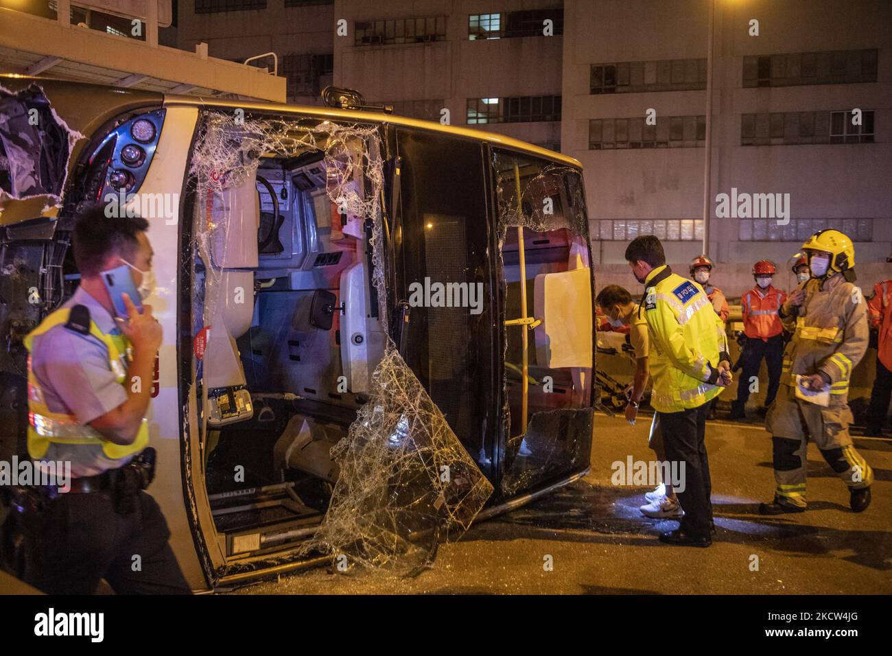 Police Officers look inside the wreckage of a rolled over bus in Tai ...
