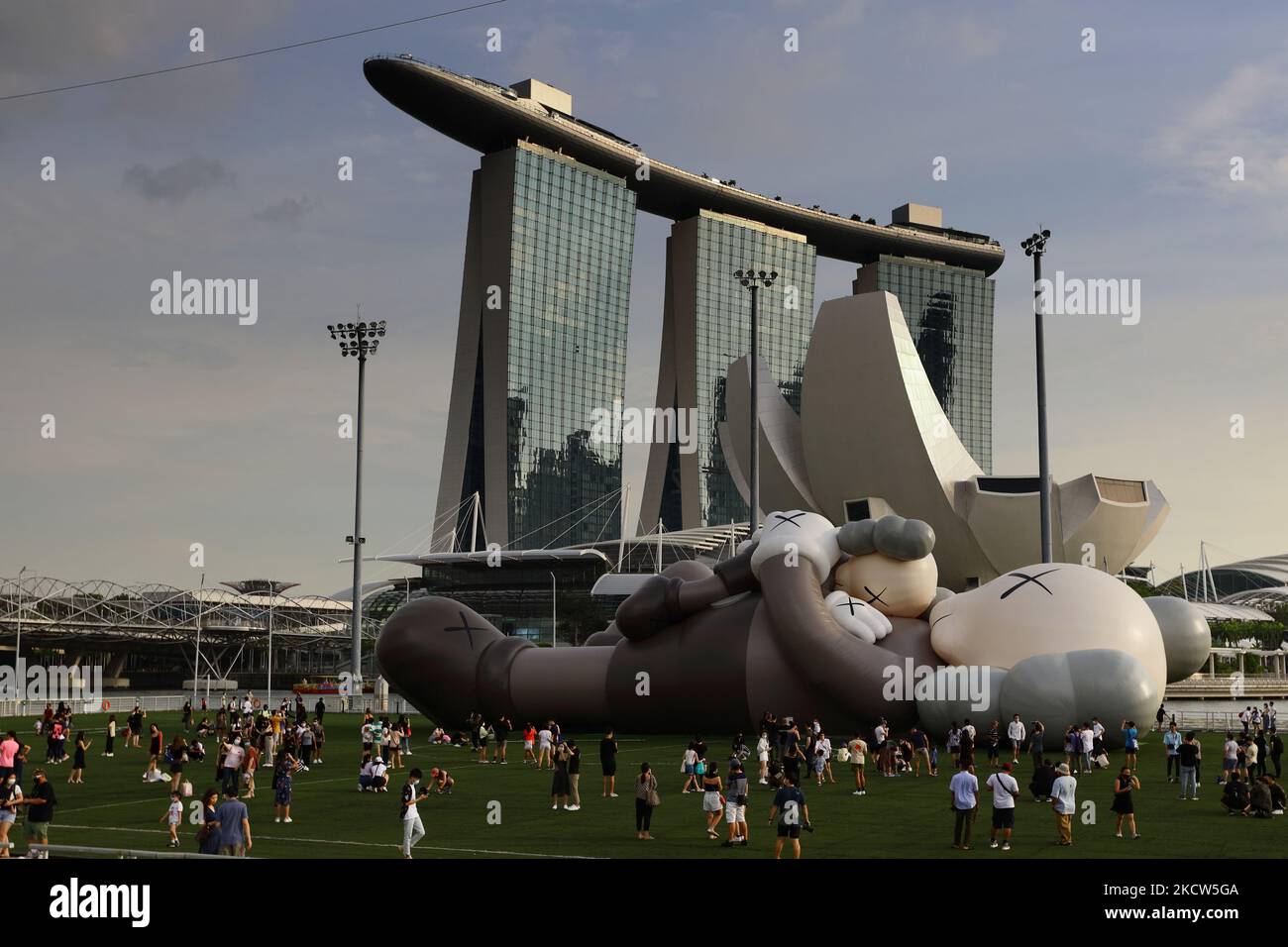 People gather to view the "KAWS:HOLIDAY" art installation featuring a ...