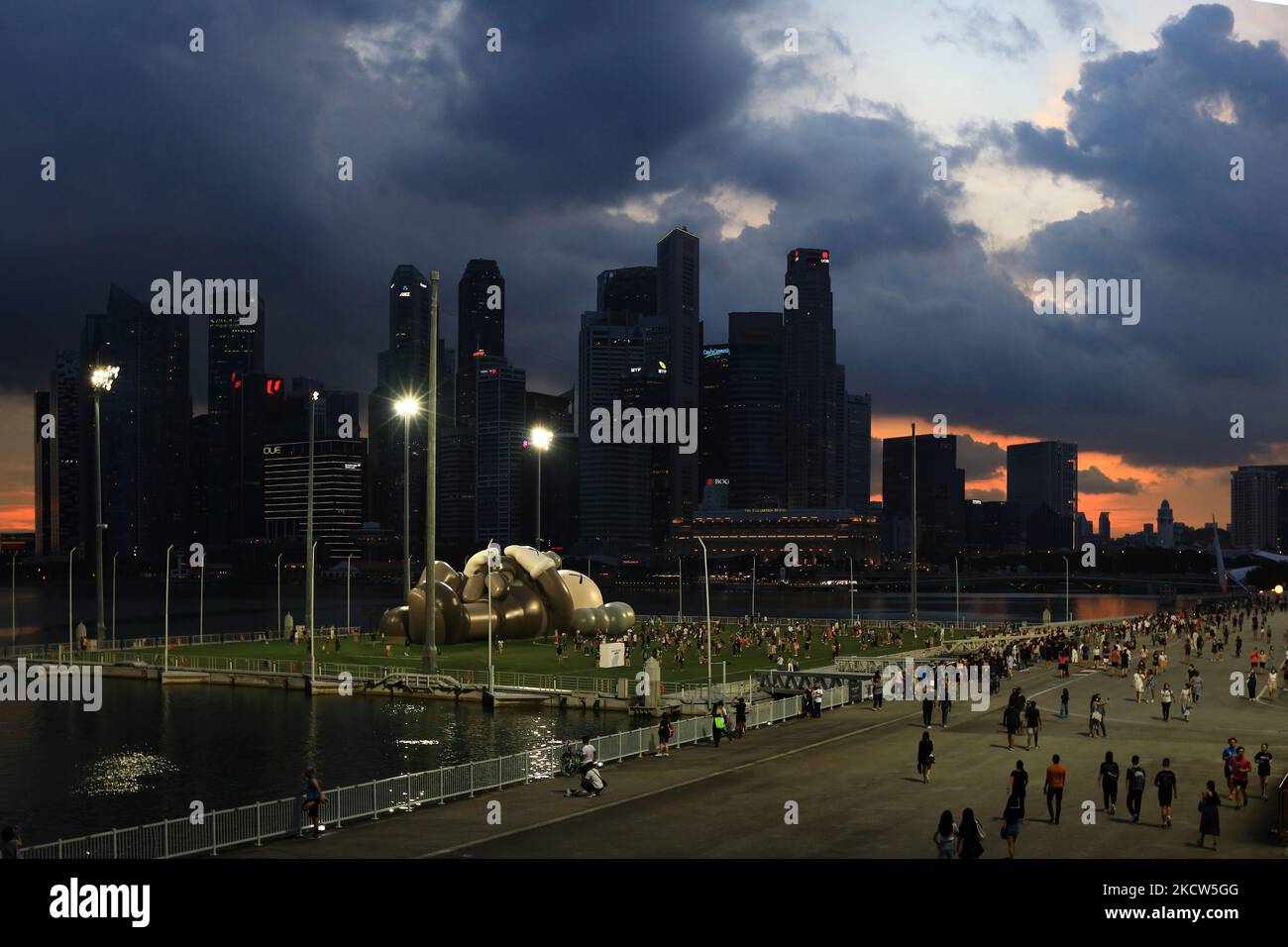 People gather to view the "KAWS:HOLIDAY" art installation featuring a ...