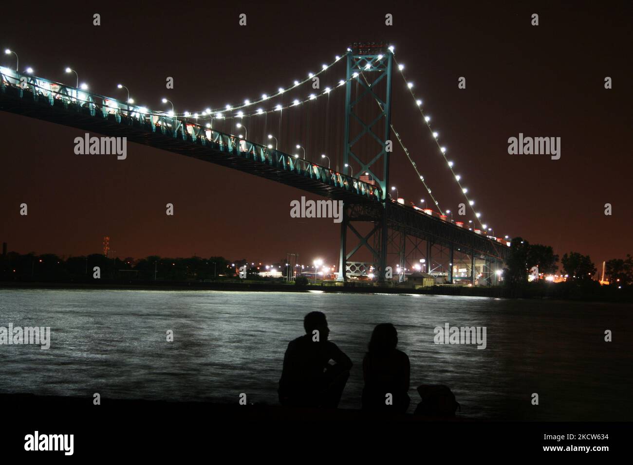 The Ambassador Bridge seen at night over the Detroit River between ...