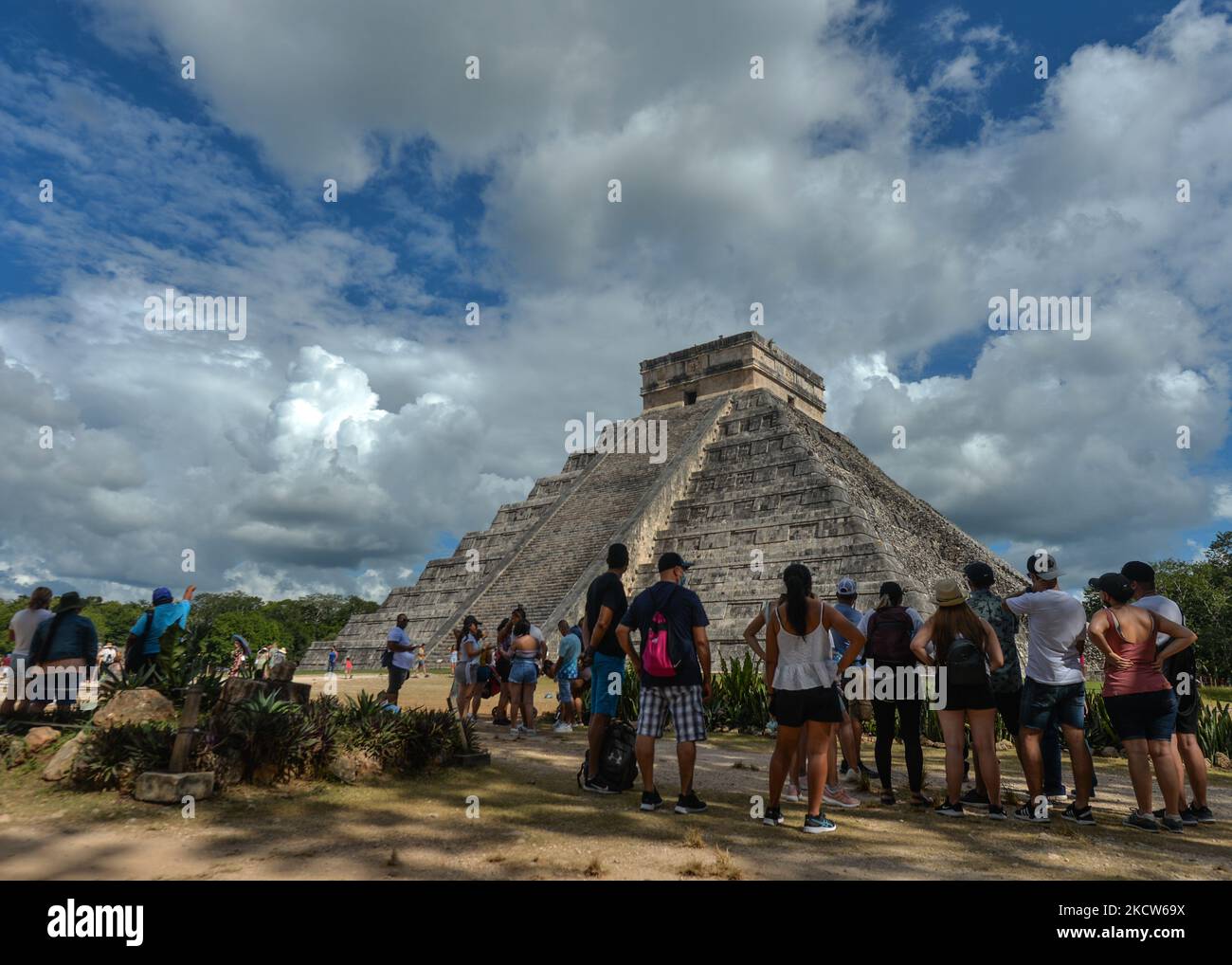 A group of tourists next to the Temple of Kukulcán (El Castillo) inside ...