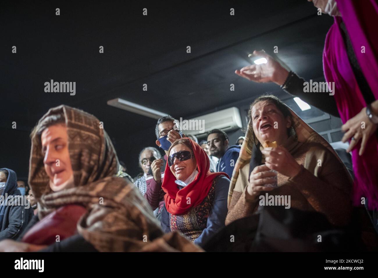 Masoumeh Ataei (C) who is a victim of an acid attack, smiles as she ...