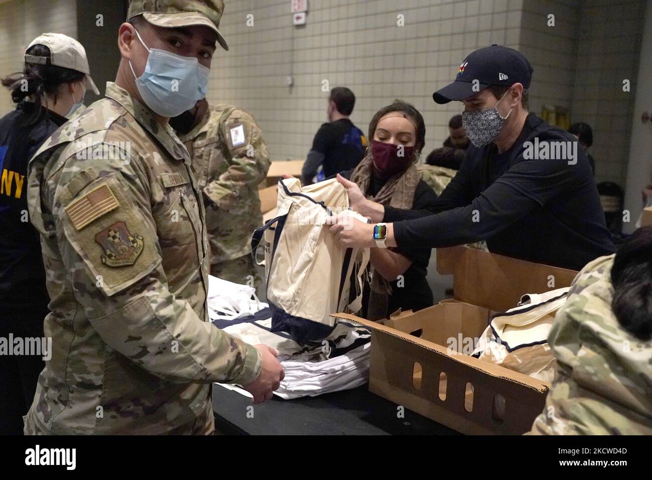 US military personnel load boxes as Lieutenant Brian Benjamin assists ...