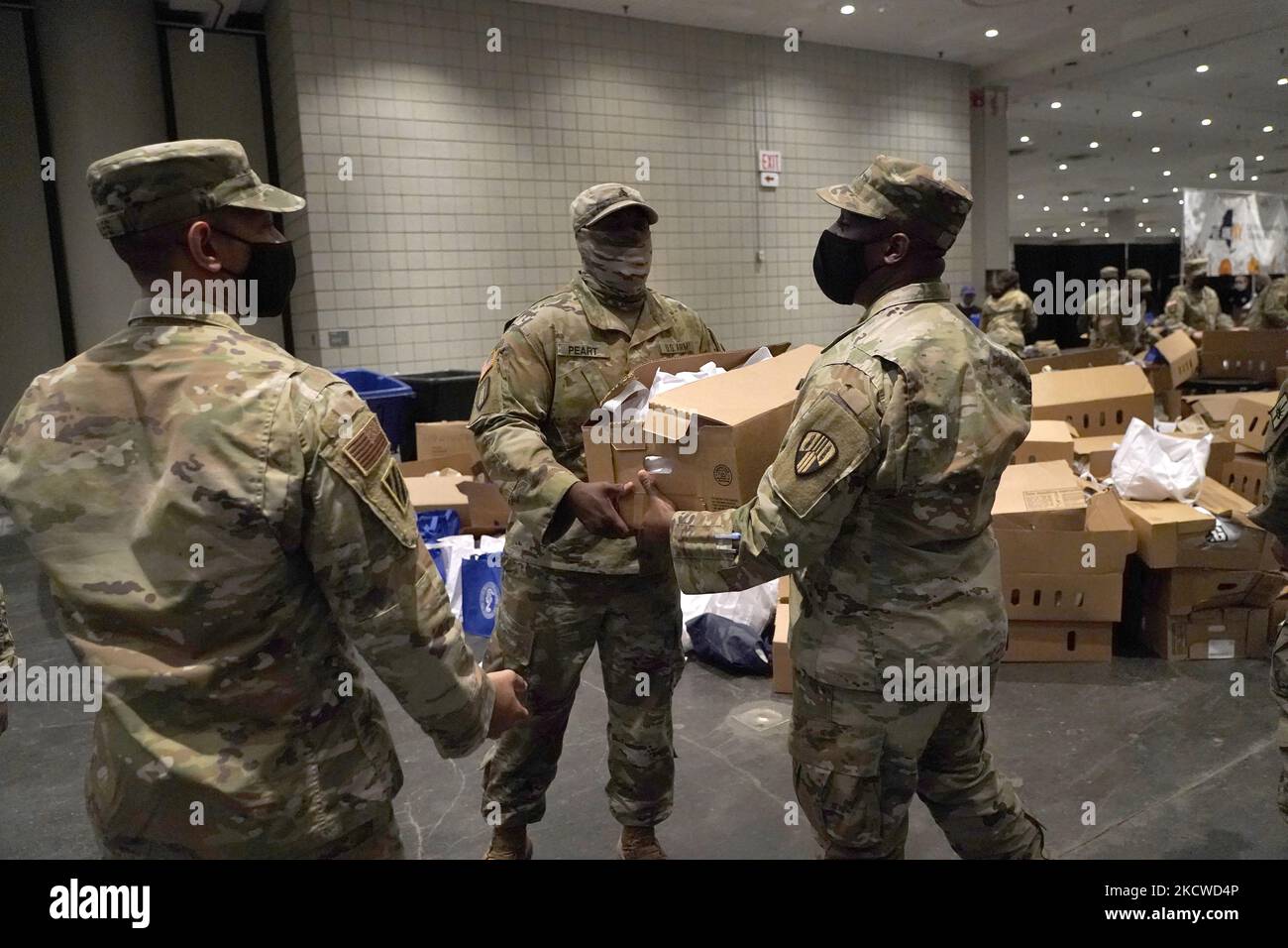 US military personnel load boxes as Lieutenant Brian Benjamin assists ...