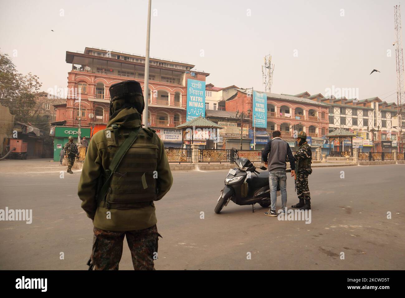 Indian forces frisk civilians during shutdown against the killing of ...