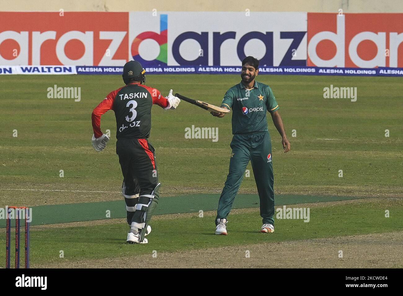 Pakistan's Asad Rouf handed over a bat to Bangladesh's Taskin Ahmed ...