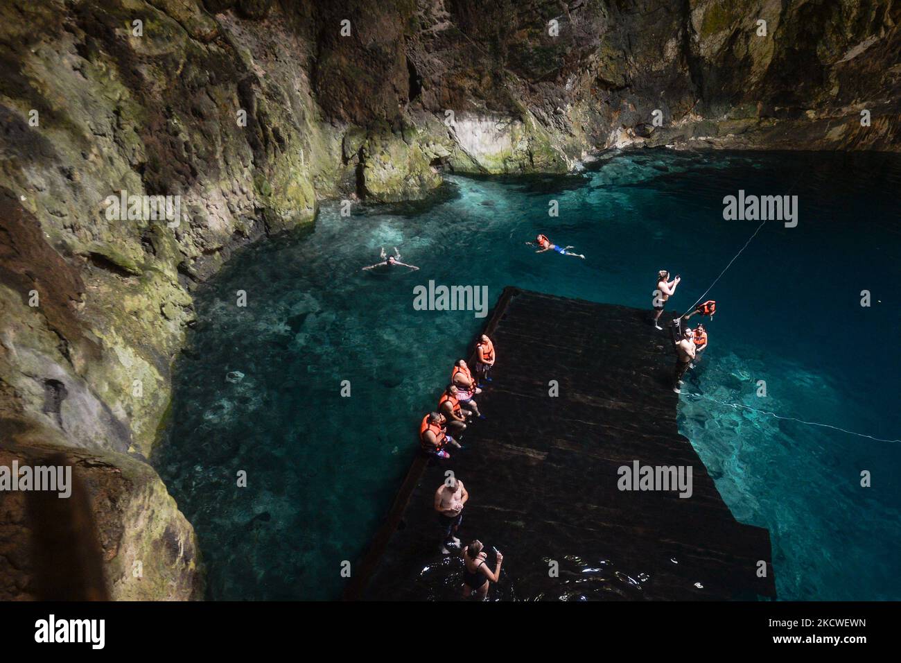 Visitors in Cenote X'ux Ha, an underground cave surrounded by ...