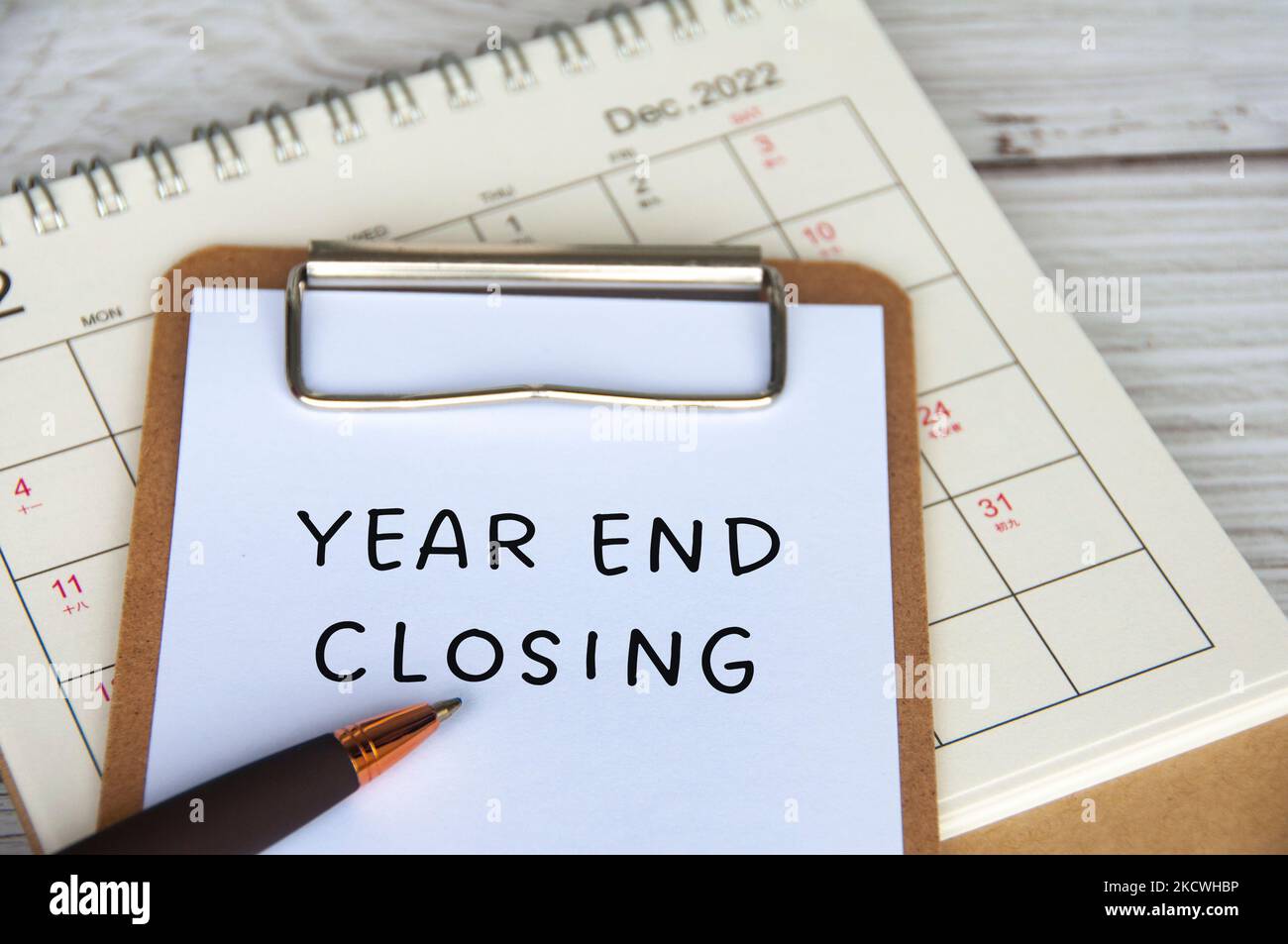 Year end closing text on white notepad with December calendar ...