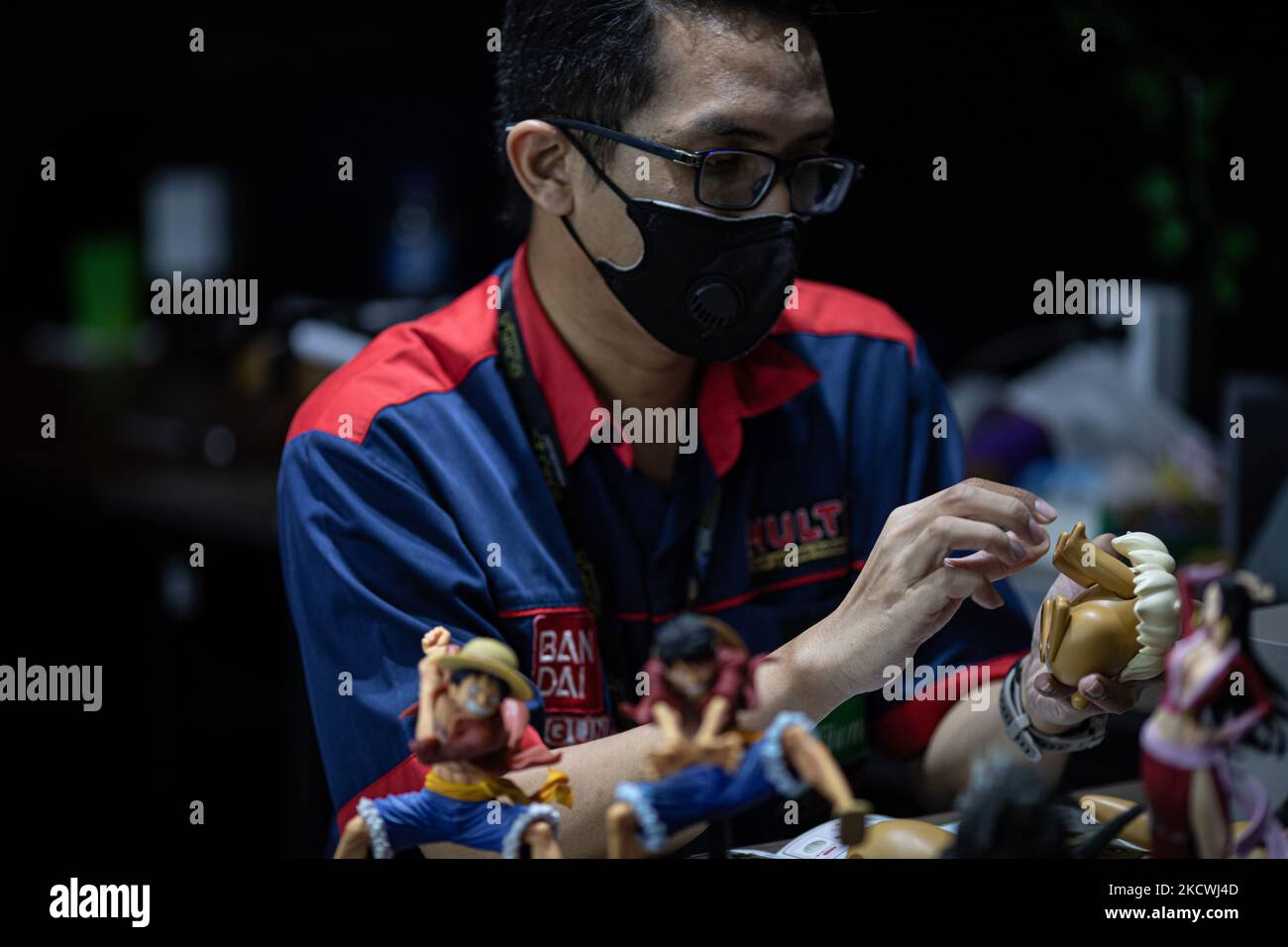 An employee is assembling toys. Multi Toys game collection store in BSD ...
