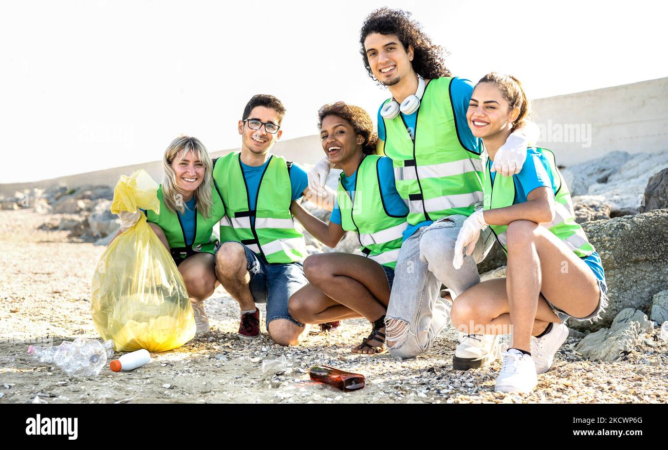 People group photo of young volunteers team wearing uniform at beach ...