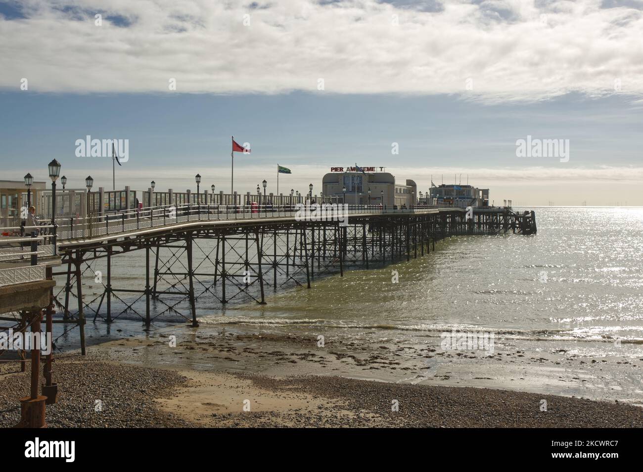 Pier and shingle beach at Worthing in West Sussex, England. With people walking Stock Photo - Alamy