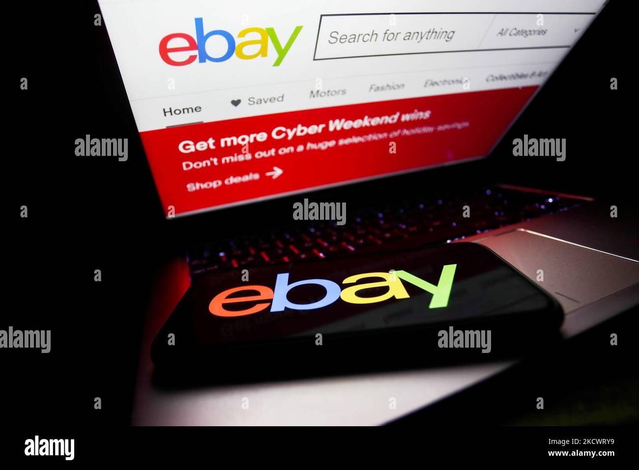 eBay logo displayed on a phone screen and eBay website displayed on a ...