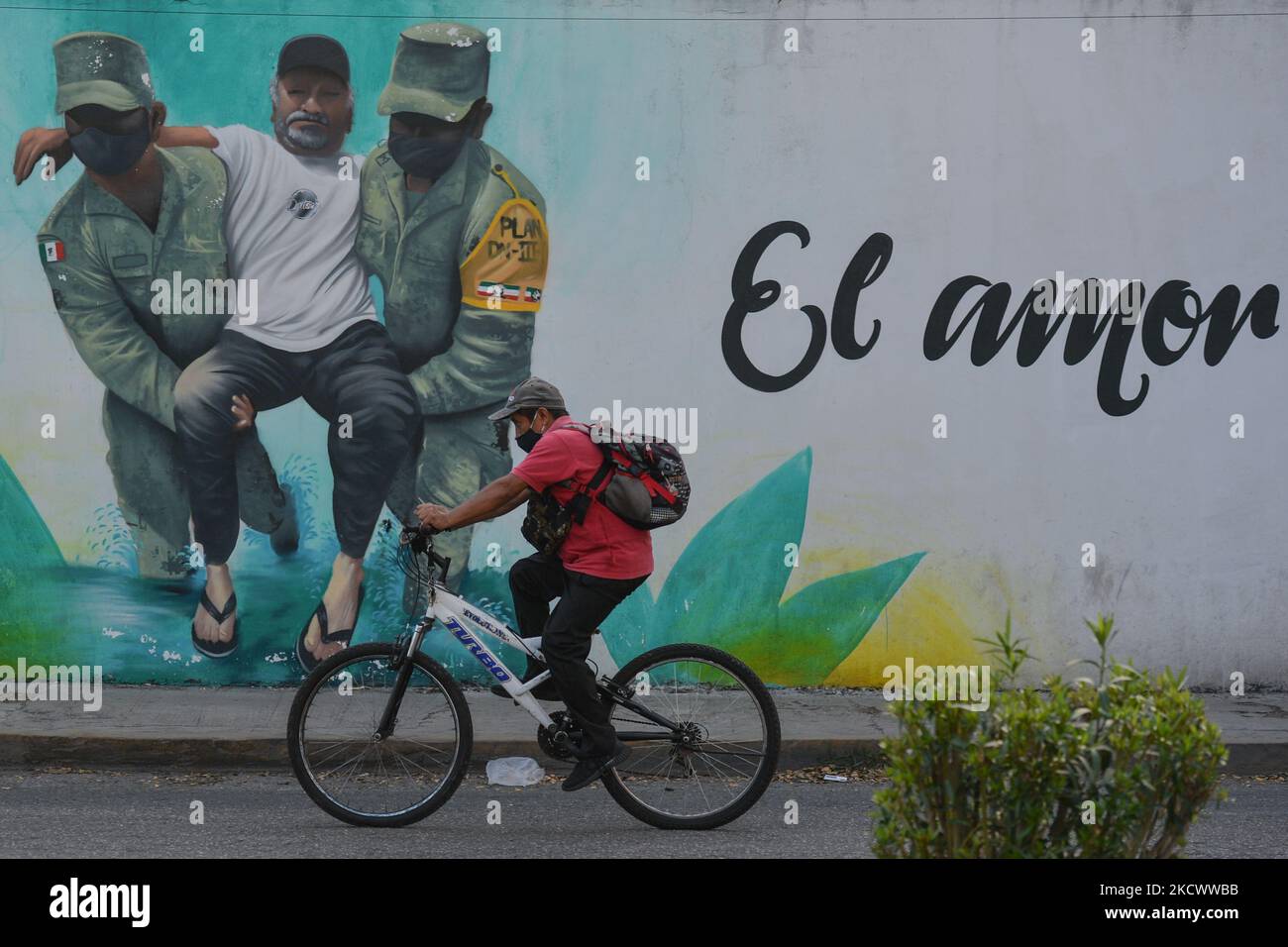 A man cycles past a mural portraying the Covid-19 first responders (in ...