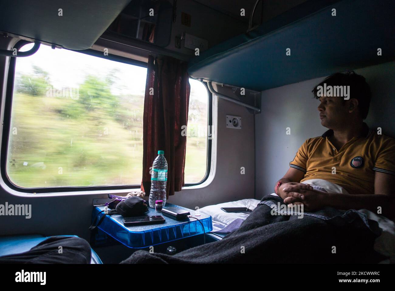 July 4th 2022 Haridwar India. A man inside a moving train looking ...