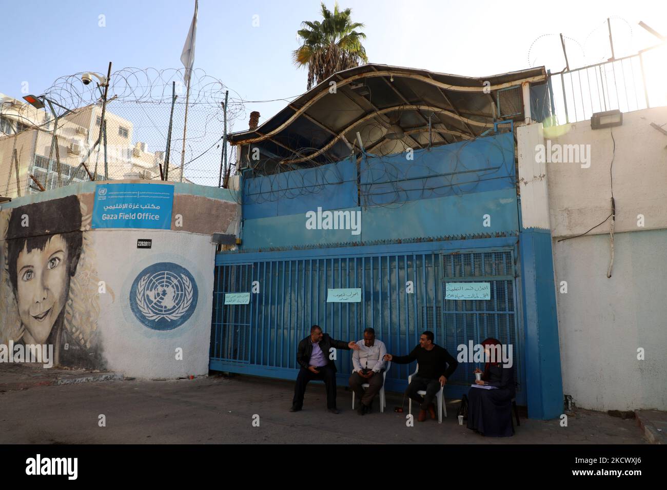 Palestinian teachers sit in front of the headquarters of the United ...