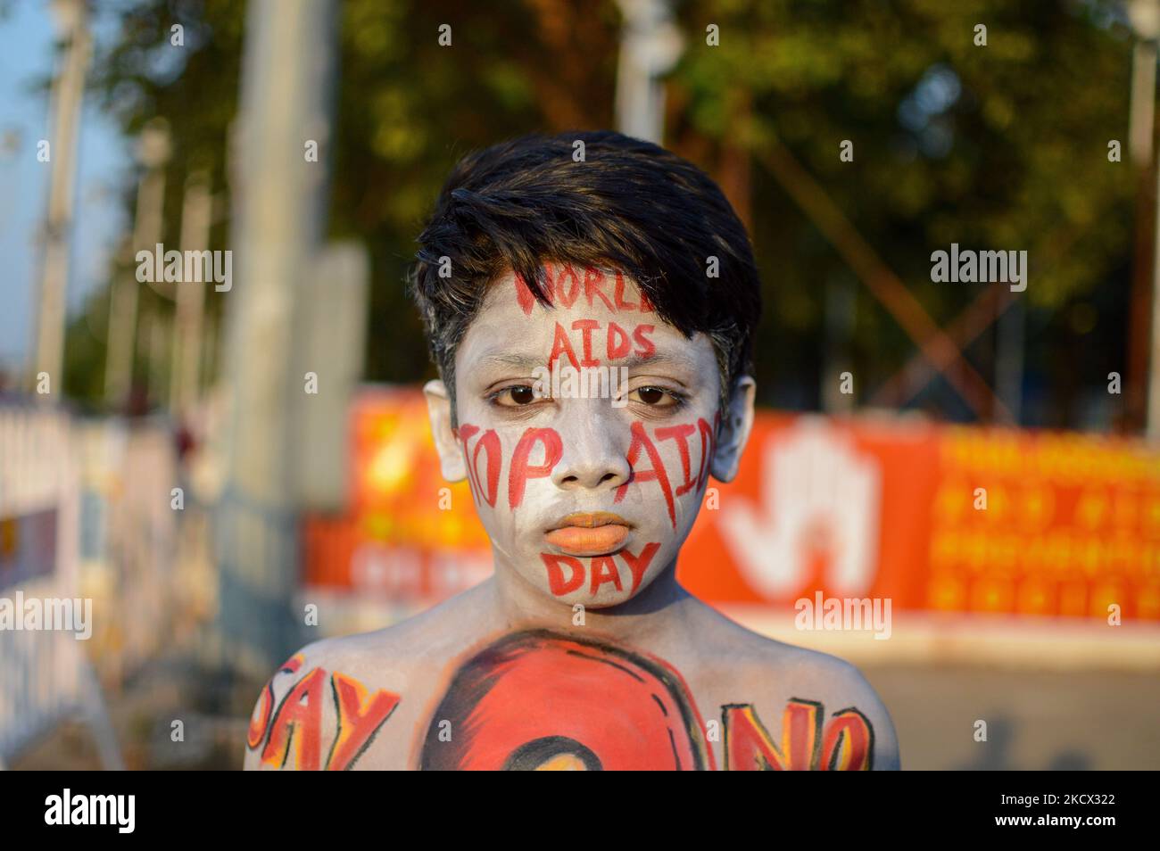 A boy is seen with painted messages on his face to raise awareness ...