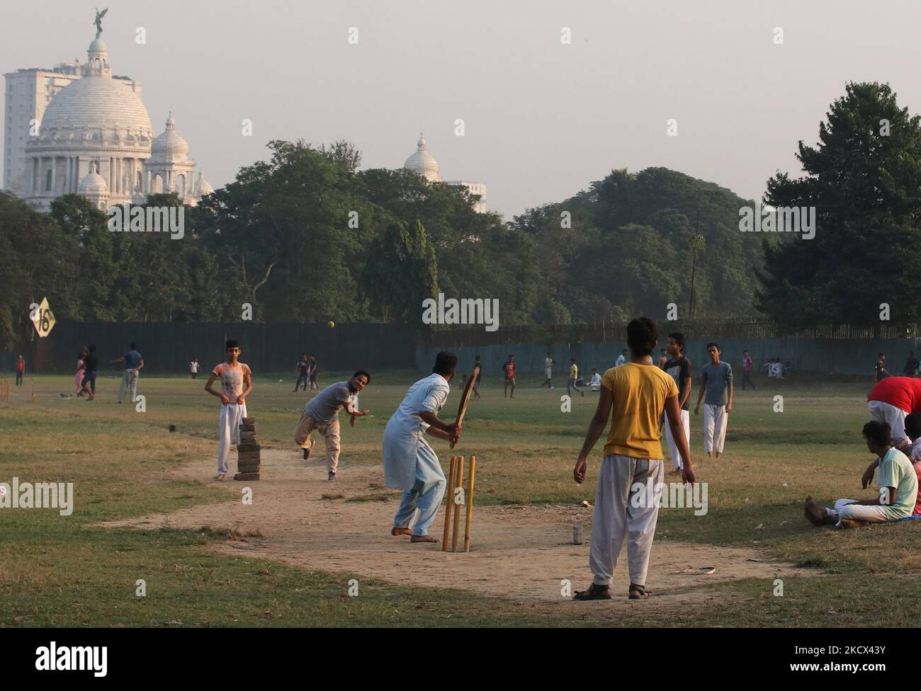 Muslim boys playing cricket and Back side Victoria Memorial hall in ...
