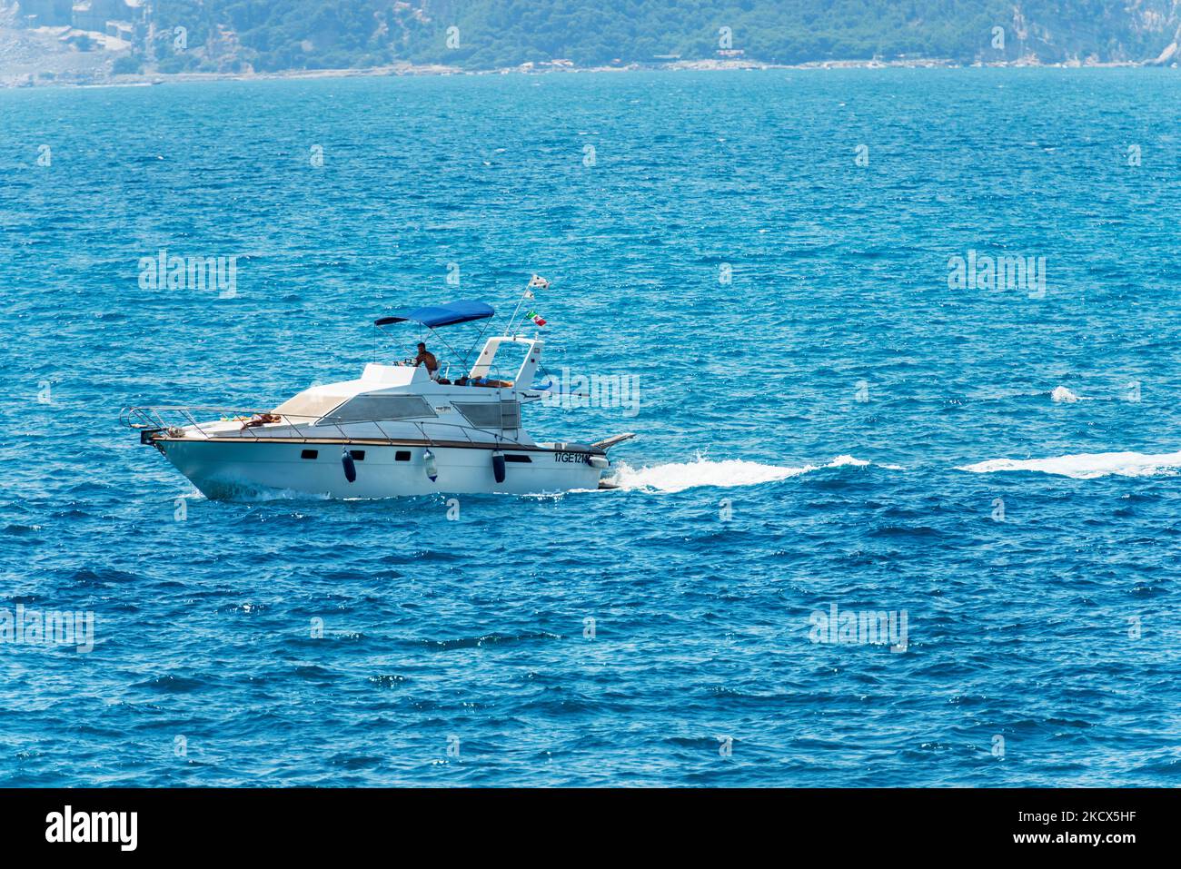 White yacht or motorboat in motion in the blue Mediterranean sea on a ...