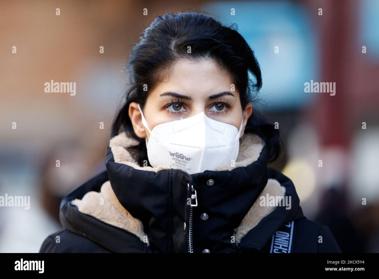 A woman wearing a face mask as protection against the covid-19 ...
