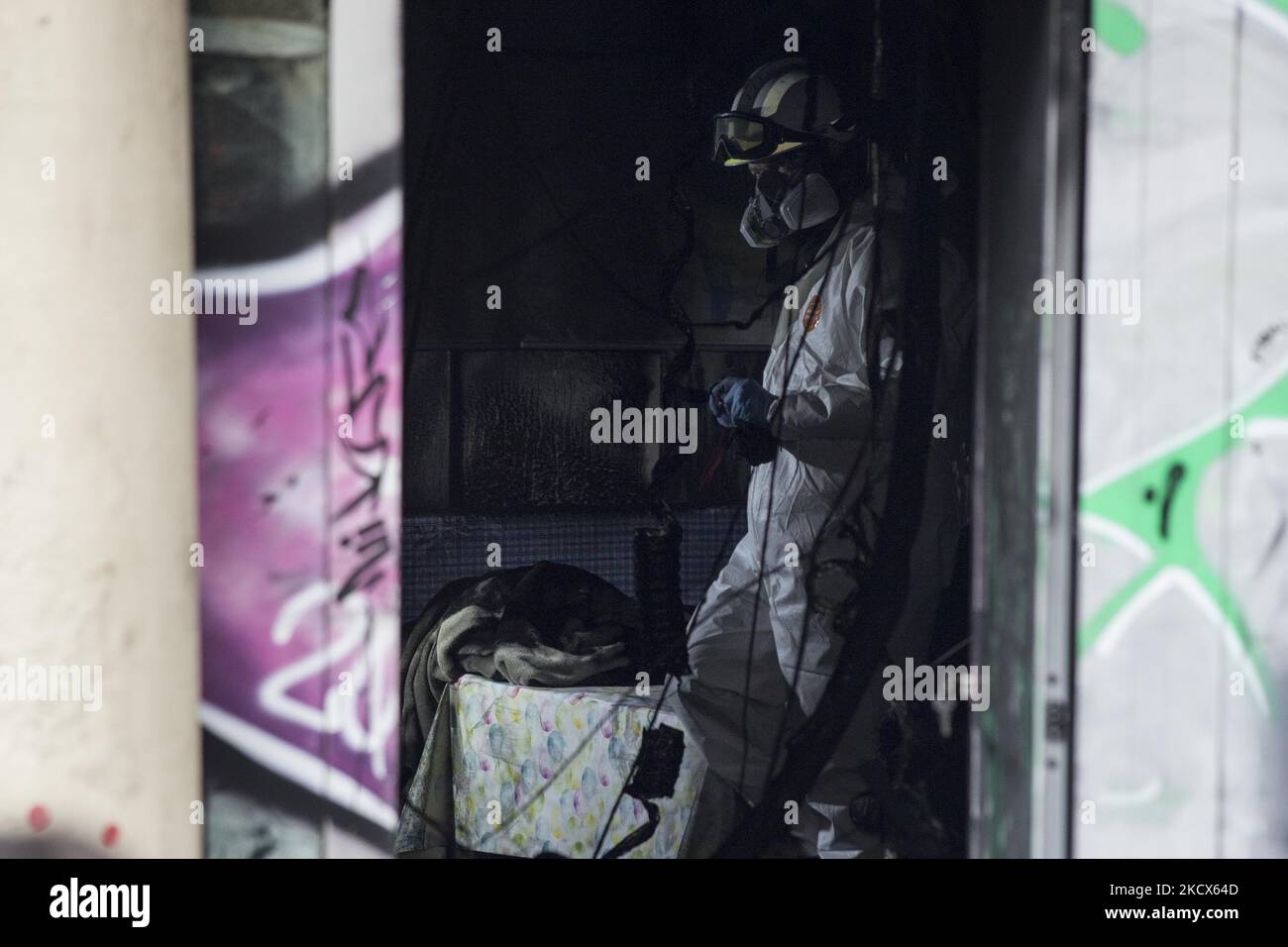 Cientific police inspect interior of the burned abandoned bank office ...