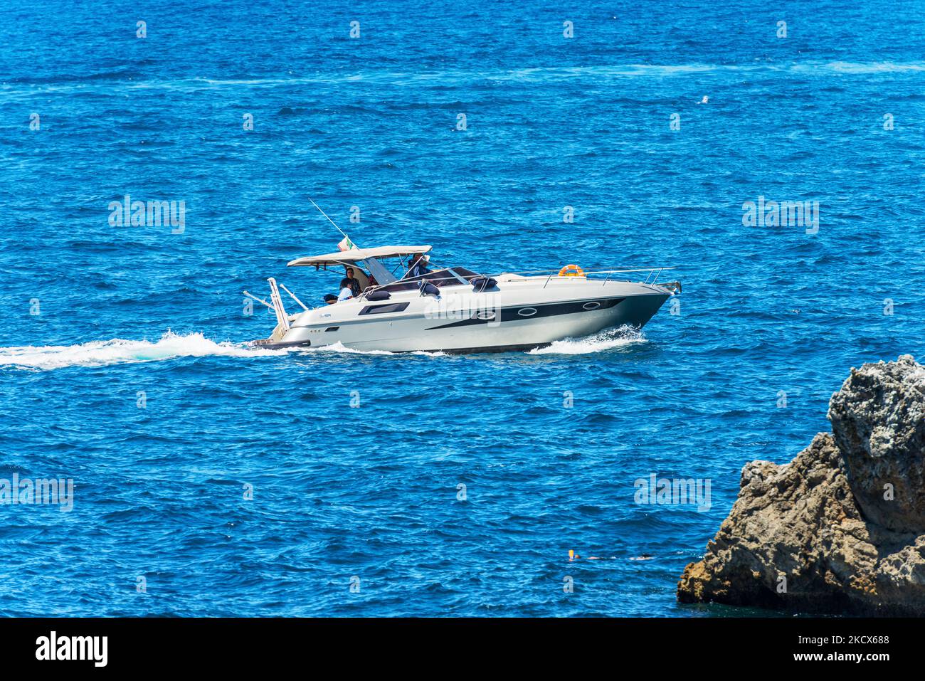 Luxury yacht or speedboat in motion in the blue Mediterranean sea on a ...
