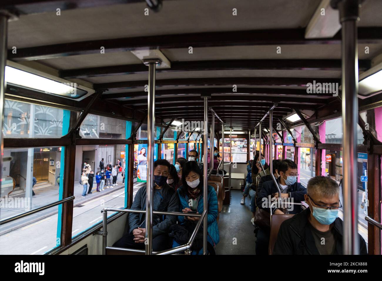 Hong Kong, 4 Dec 2021, Masked people ride on a Hong Kong tramway ...