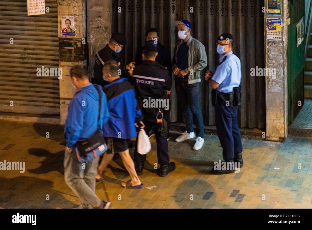 Hong Kong, 4 Dec 2021, Police officers identify two men in Sai Ying Pun ...