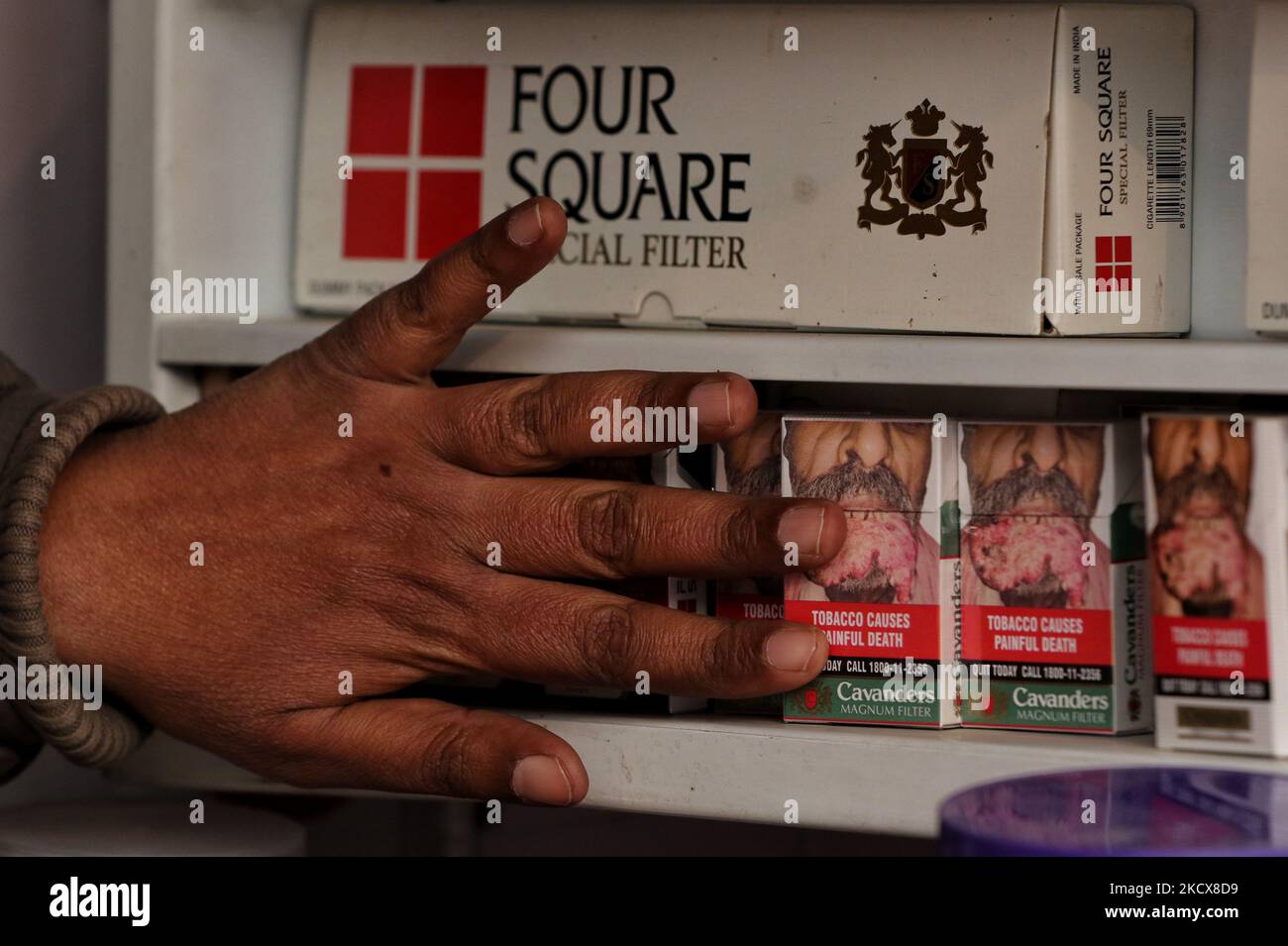 A man arrange Four Square Special Filter Cigarettes at his Shop in ...