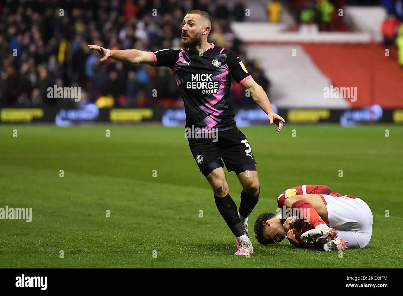 Dan Butler of Peterborough United gestures at the assistant referee ...