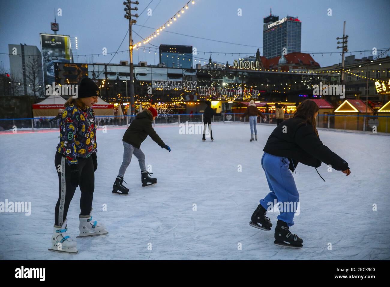 People are skating on ice during Christmas market in Katowice, Poland ...