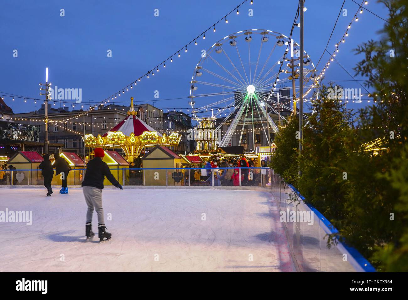 People are skating on ice during Christmas market in Katowice, Poland ...