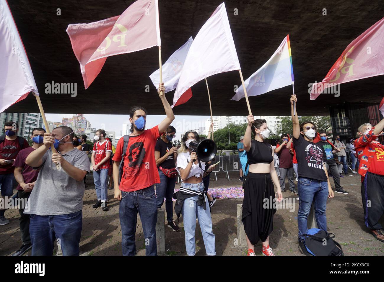 Demonstrators lift a banner as they participate in a protest against ...
