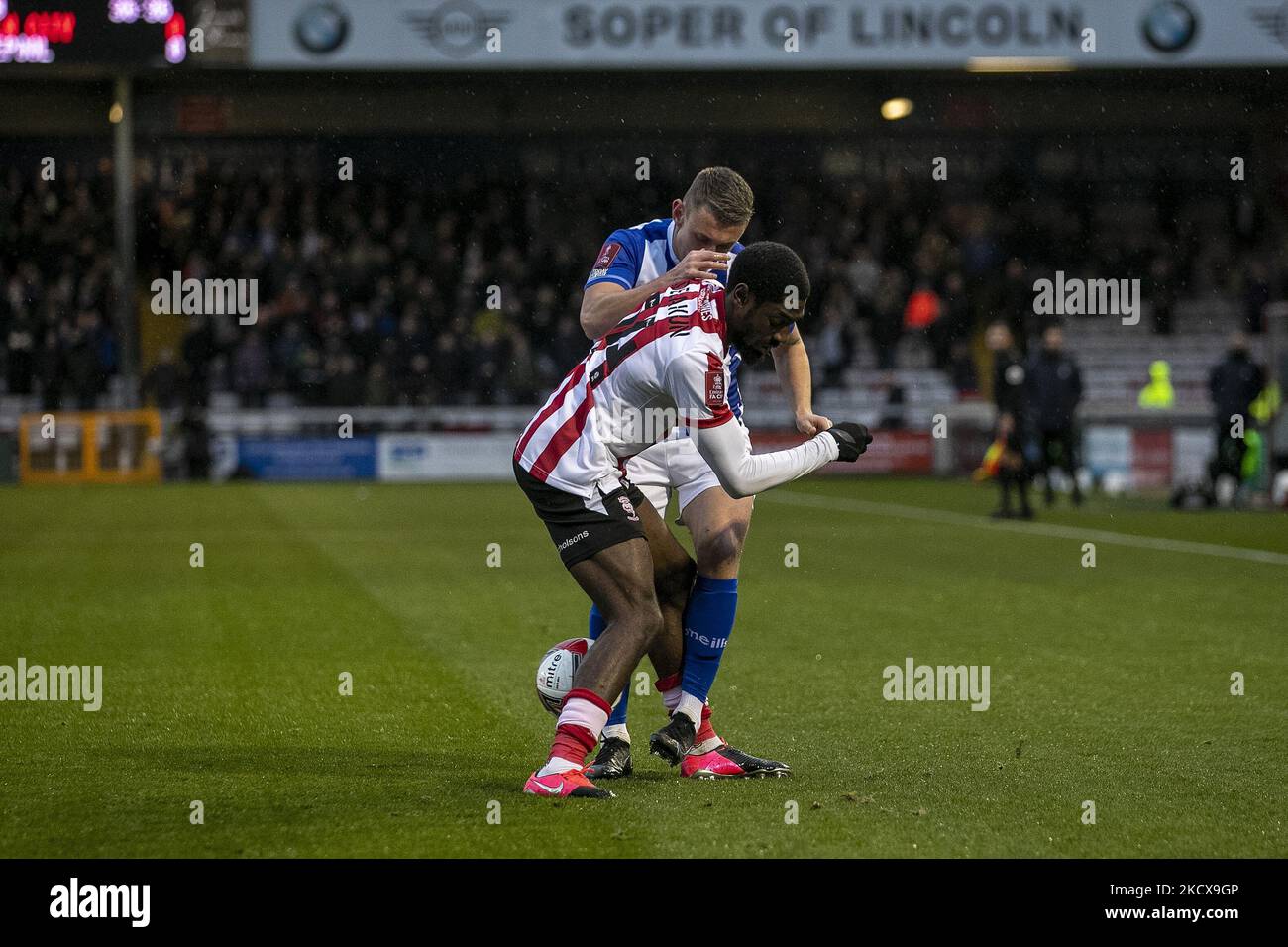 Lincoln City's Hakeeb Adelakun battles for possession with Hartlepool ...