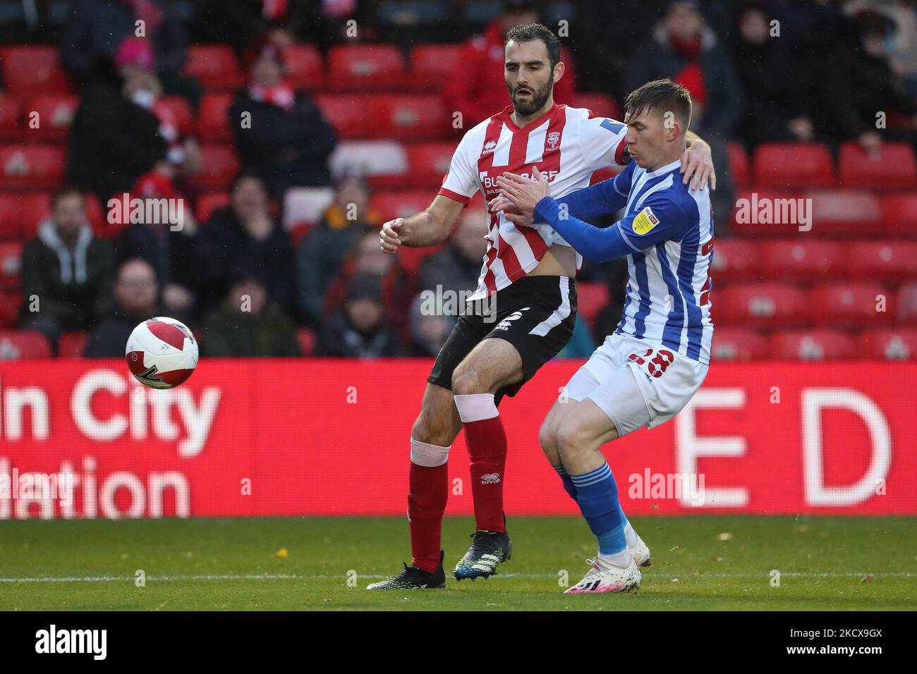 Hartlepool United's Matty Daly in action with Adam Jackson of Lincoln ...