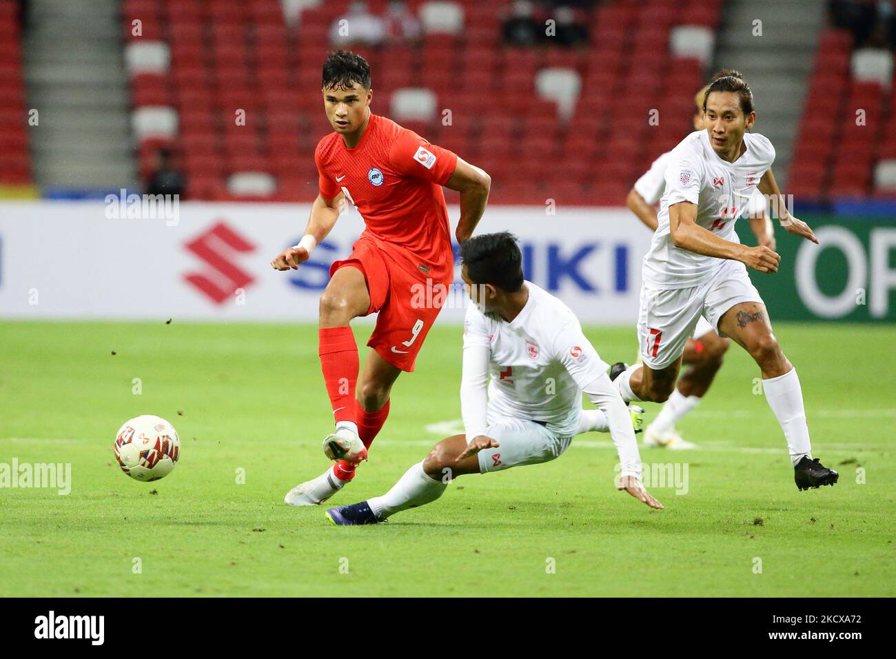 Ikhsan Fandi of Singapore shoots past Nyein Chan of Myanmar during the ...