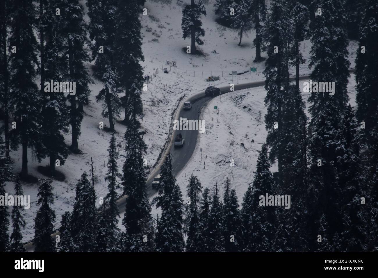 Vehicles move towards Gulmarg are pictured through snow covered roads ...