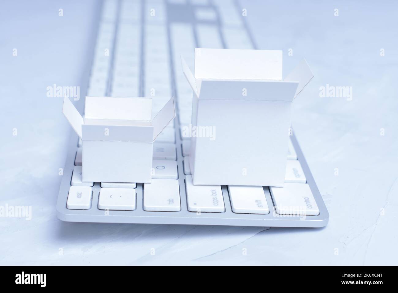 Small white shipping boxes placed on a keyboard. E-commerce delivery ...