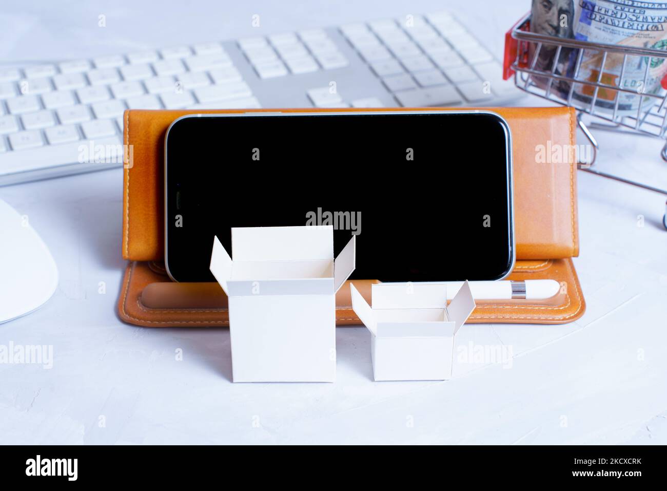 Unpacked miniature delivery boxes standing in front of the smartphone ...