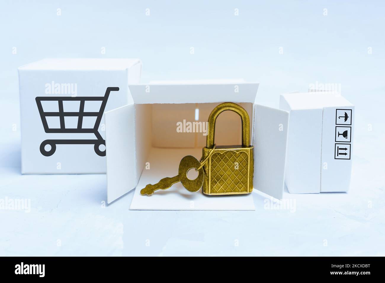 Group of small marked delivery boxes and tiny padlock with a key. E ...