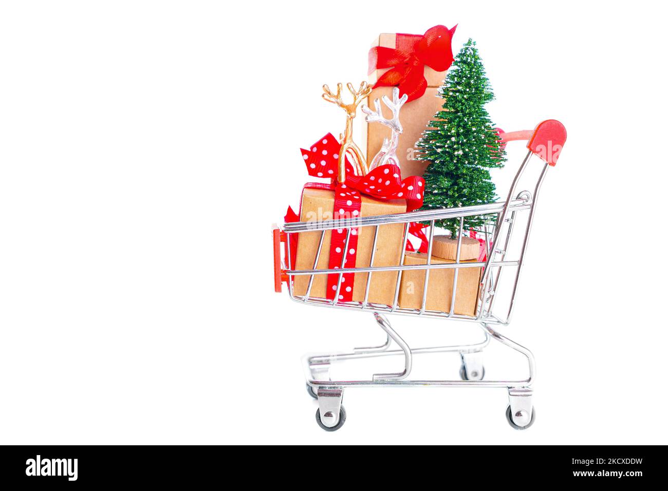 Toy christmas tree, deers and gift boxes packed in a miniature shopping ...