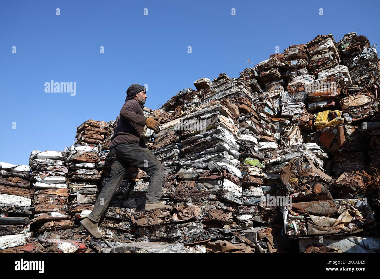 This photo taken on December 6, 2021 shows scrap metal being pressed ...