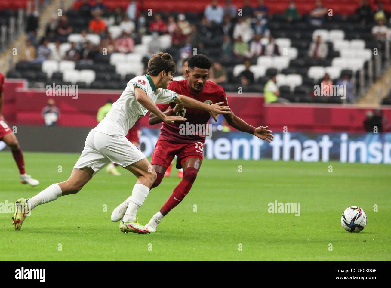 (13) MUSAAB KHIDIR of Qatar team battles for possession (11) HASAN ...