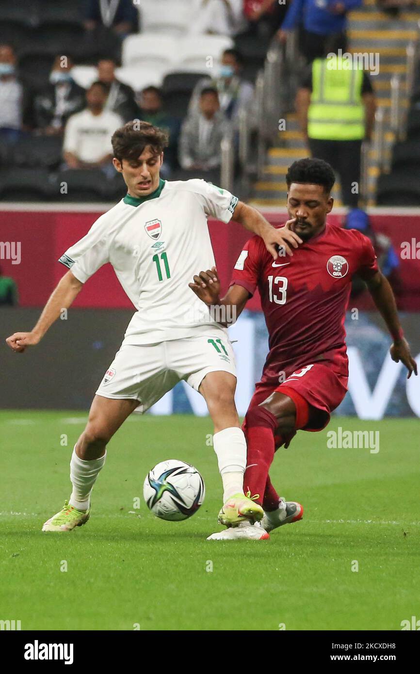 (13) MUSAAB KHIDIR of Qatar team battles for possession (11) HASAN ...